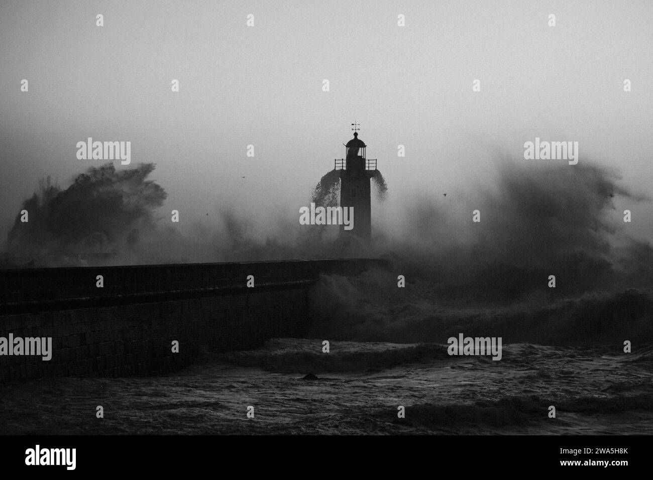 Portuguese Lighthouse with stormy Atlantic wave. Black and white photo ...