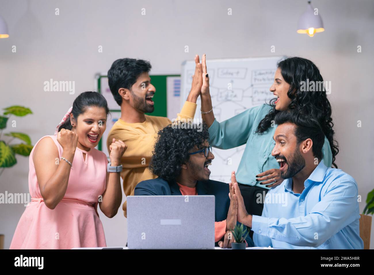 Group of team members celebrating success after seeing received mail ...