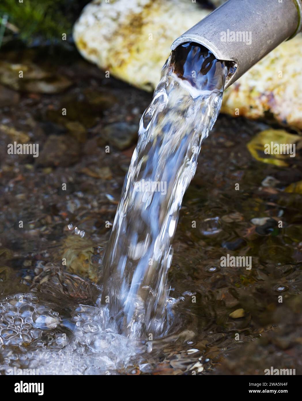 Fresh water emerging from a pipe. Image illustrating water scarcity and ...