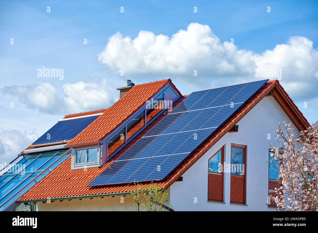 Modern house with solar roof to generate electricity and hot water ...