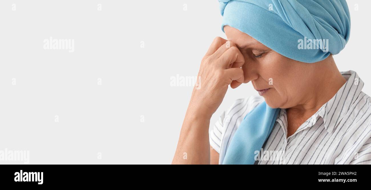 Sad mature woman after chemotherapy on light background with space for ...