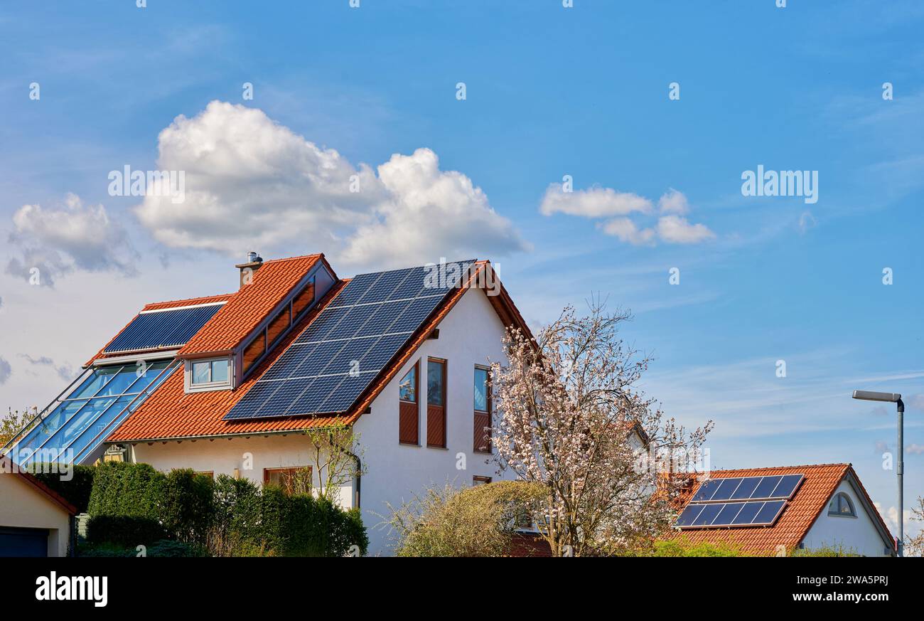 Modern houses with solar roofs to generate electricity and hot water ...