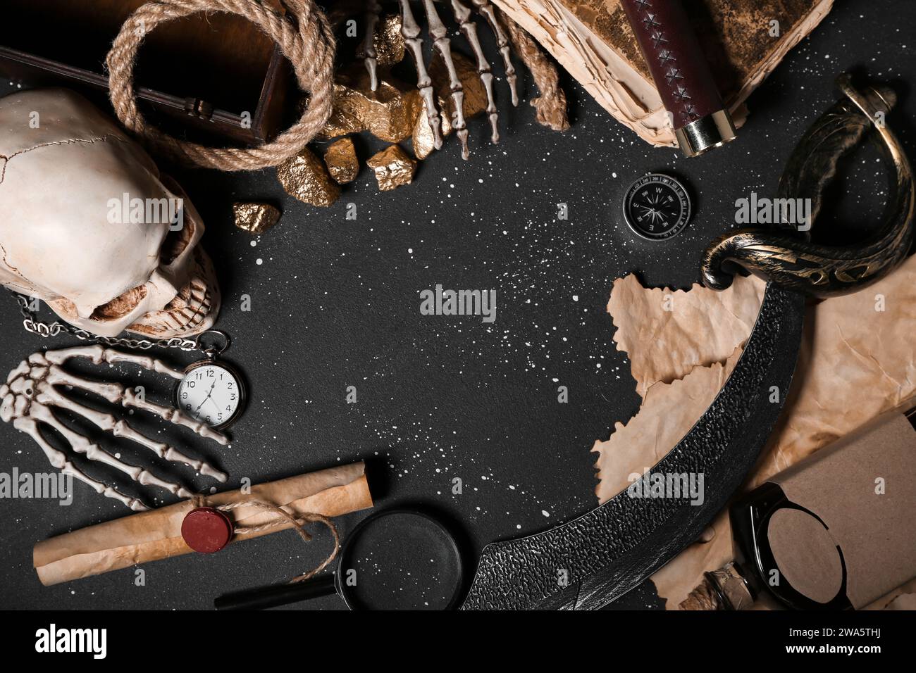 Travel equipment with golden nuggets, human skull and net on black ...