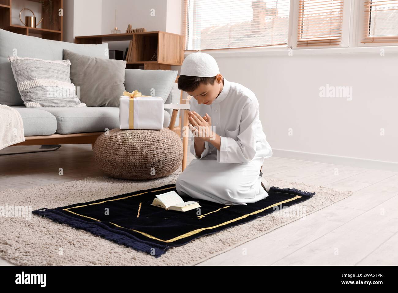 Little Muslim boy praying at home Stock Photo - Alamy