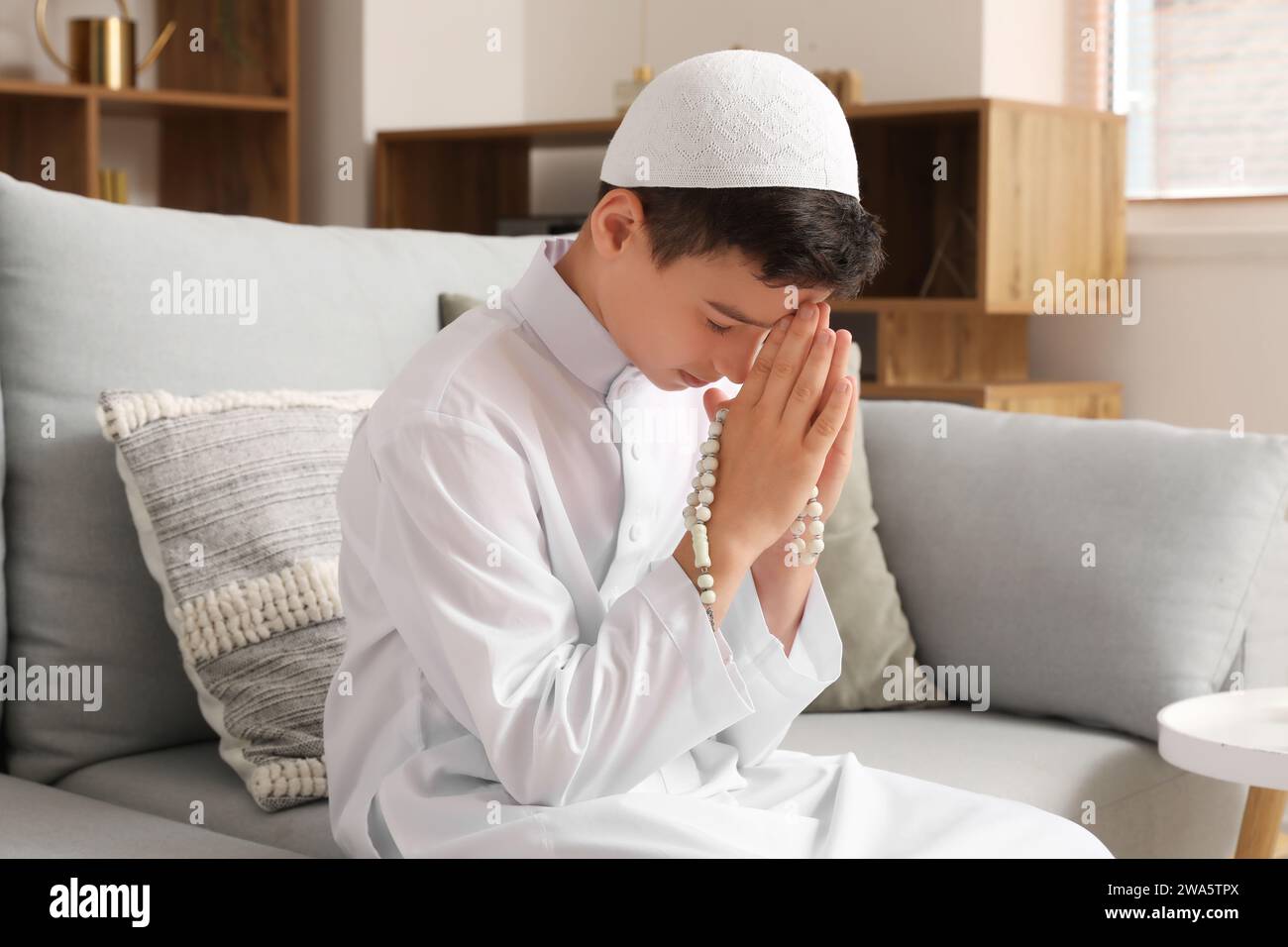 Little Muslim boy praying at home Stock Photo - Alamy