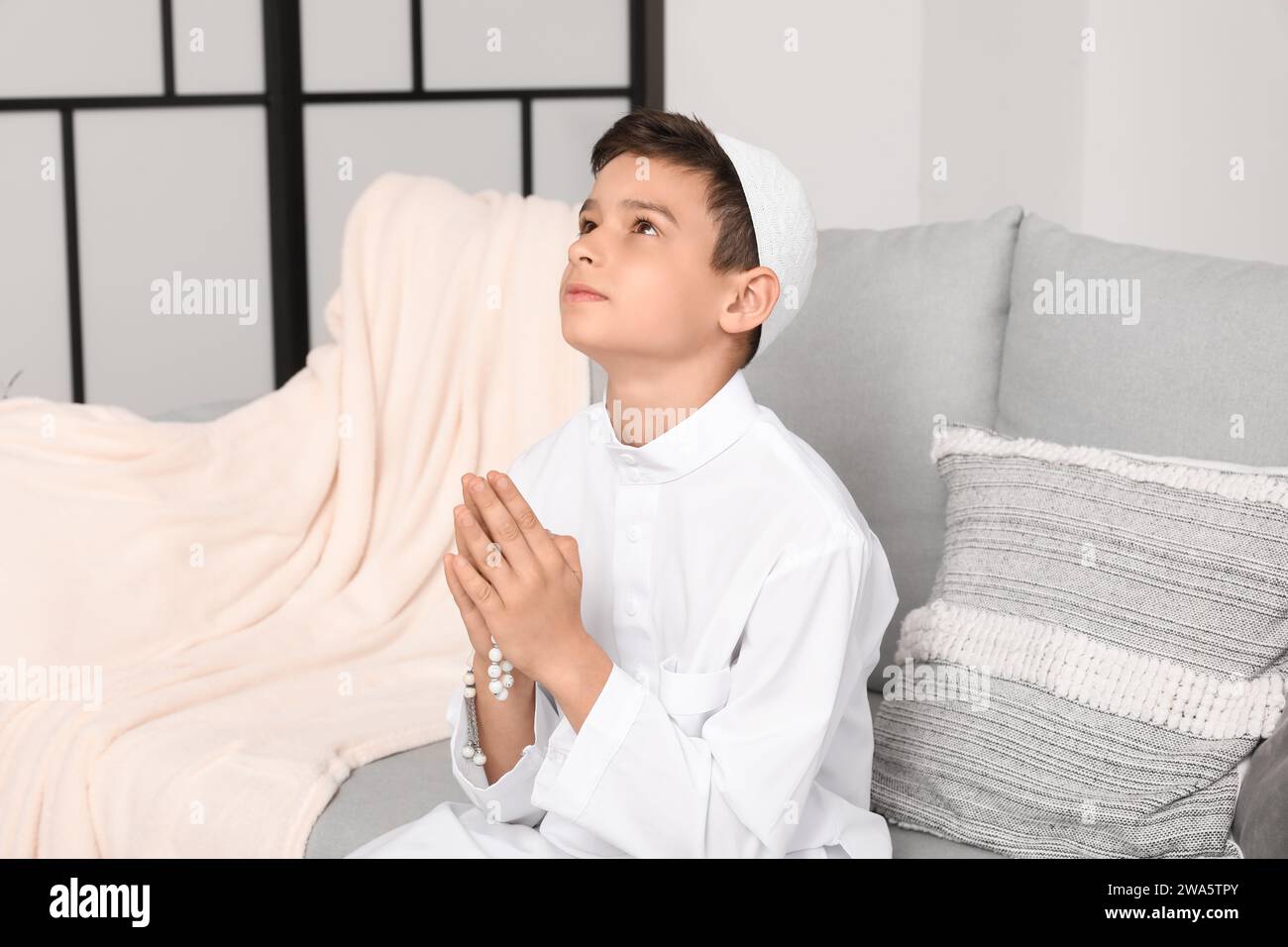 Little Muslim boy praying at home Stock Photo - Alamy