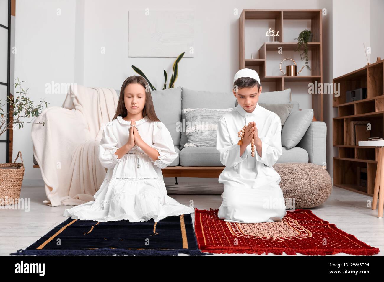 Little Muslim children praying at home Stock Photo - Alamy