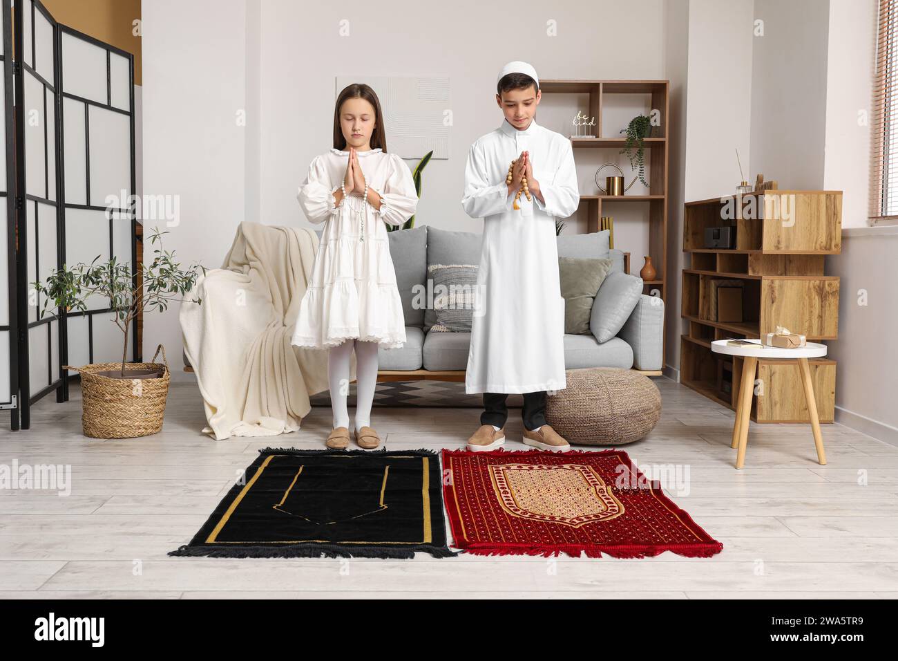 Little Muslim children praying at home Stock Photo - Alamy