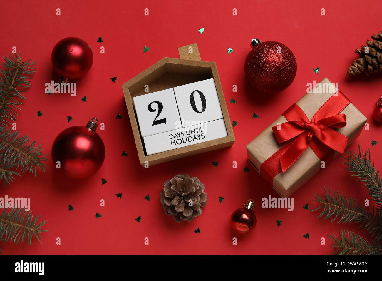 Calendar with text 20 DAYS UNTIL HOLIDAYS and Christmas decor on red ...