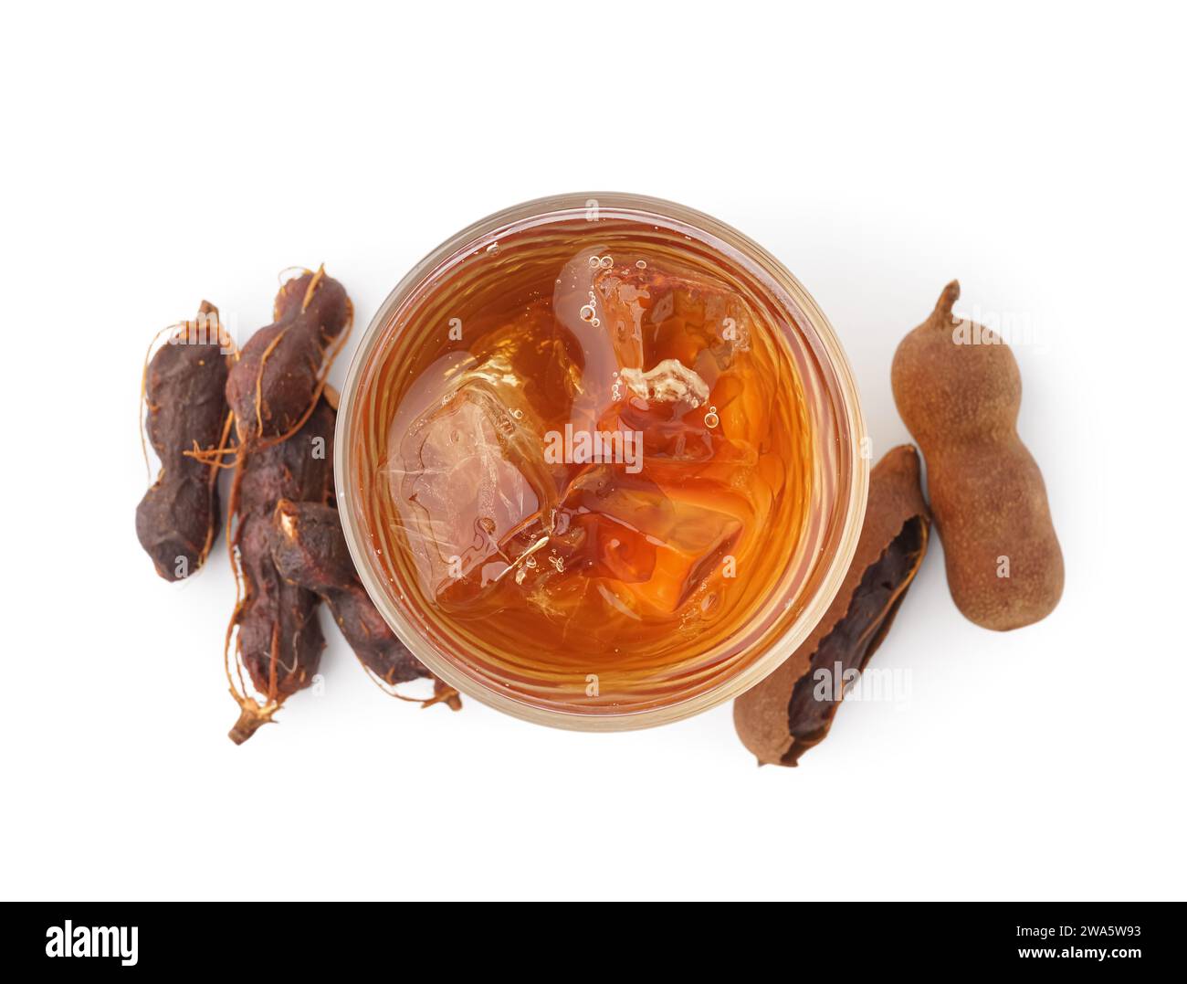 Glass of tasty tamarind drink and fruits on white background Stock ...