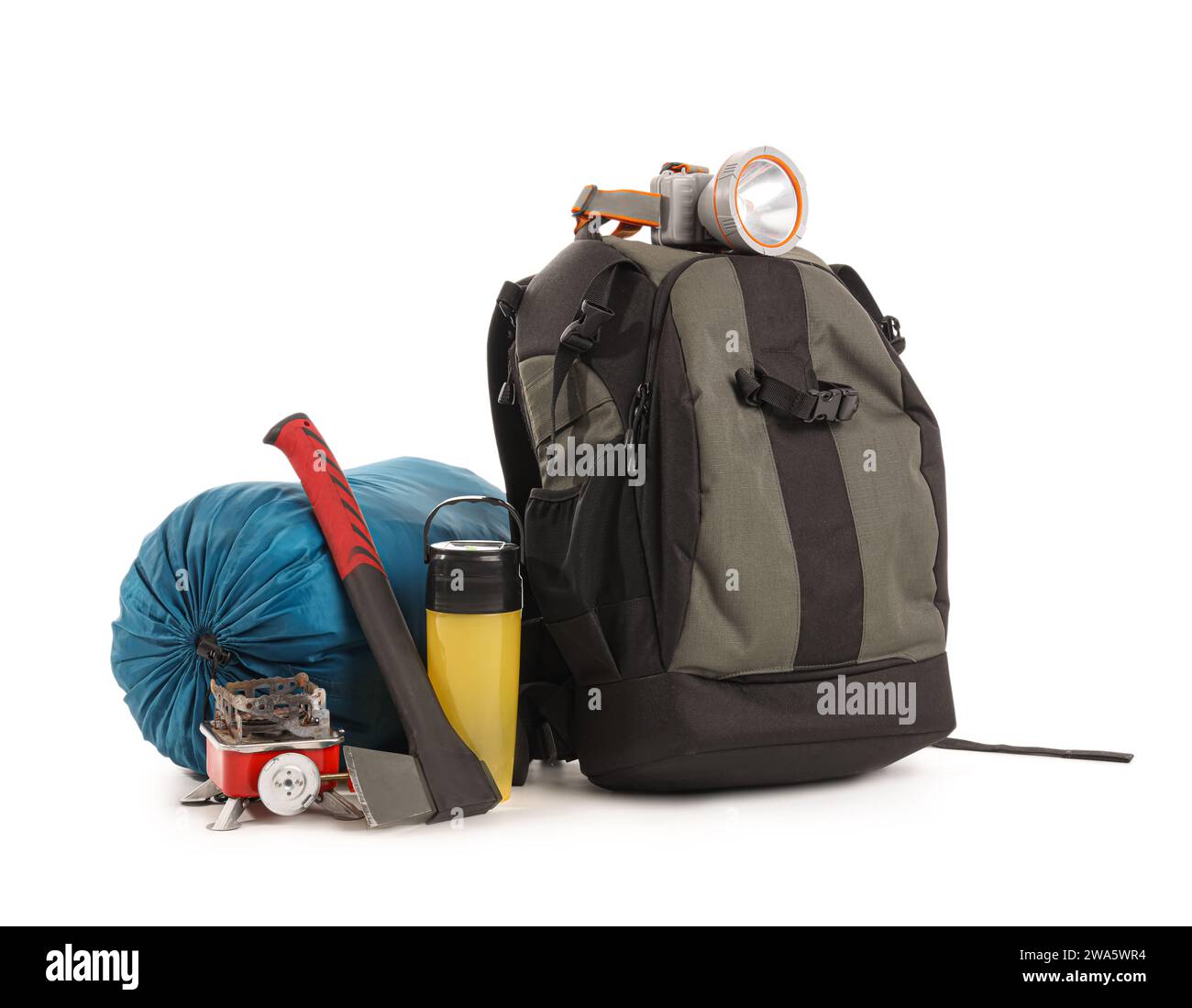 Set of camping equipment with backpack, flashlight and hatchet on white ...