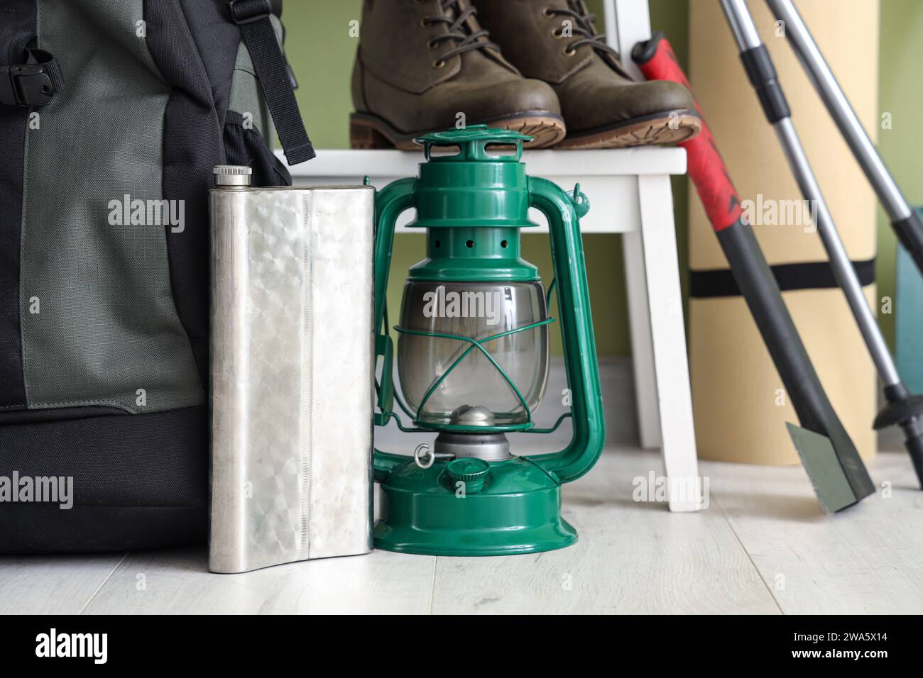 Set of camping equipment with oil lantern and flask indoors, closeup Stock Photo - Alamy