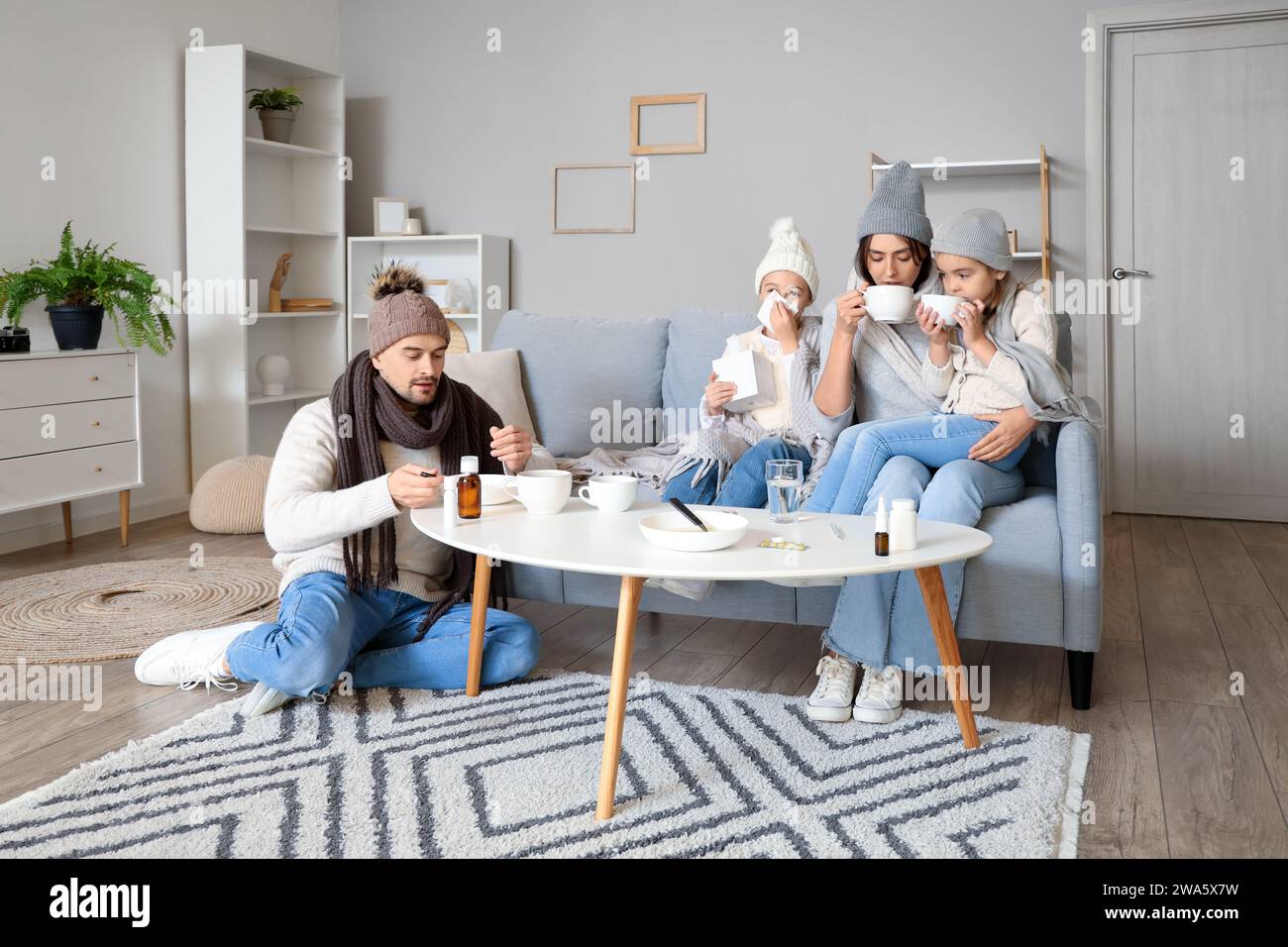 Ill little girls with their parents drinking tea at home Stock Photo ...
