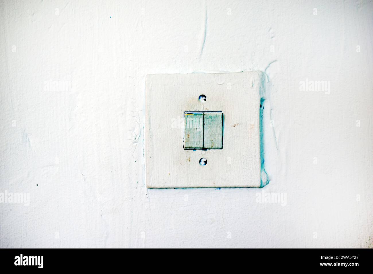 An old light switch on the wall. Electrical switching. Painted switch ...