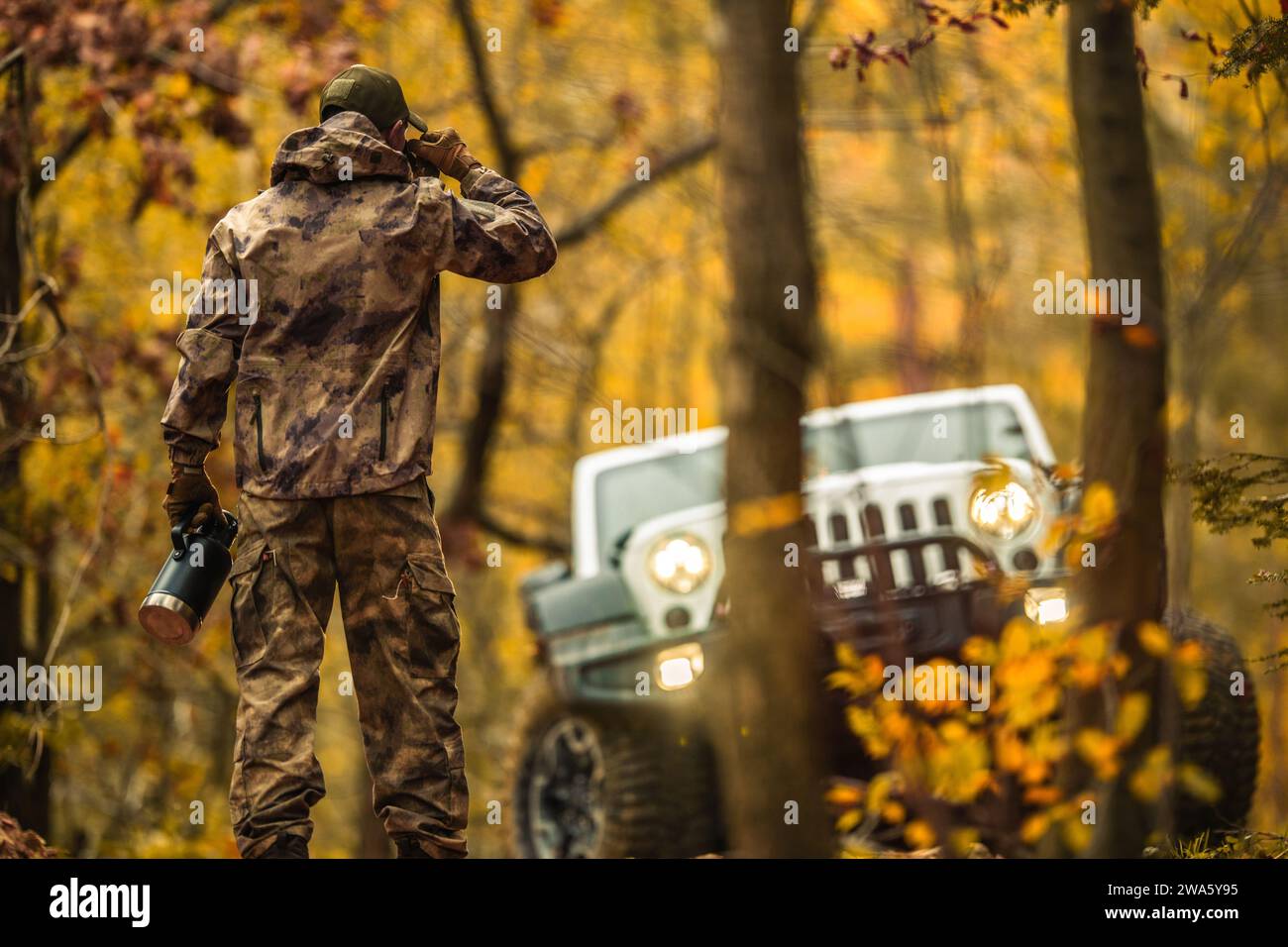 A Man with Thermos in His Hand Drinking Hot Coffee While on an Off Road ...