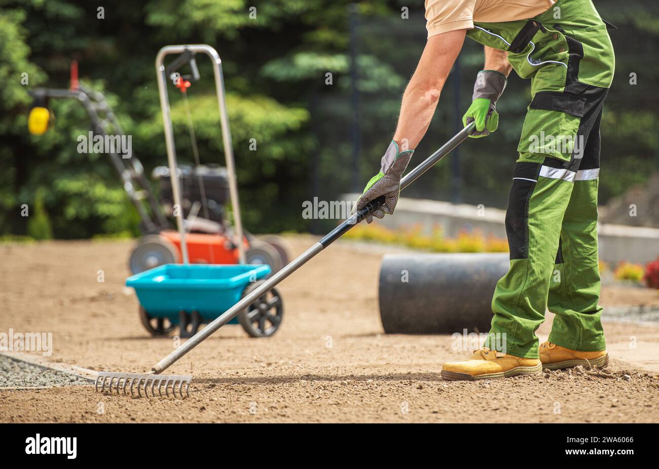Professional Landscaper Preparing Backyard Soil for a Grass Seeding ...