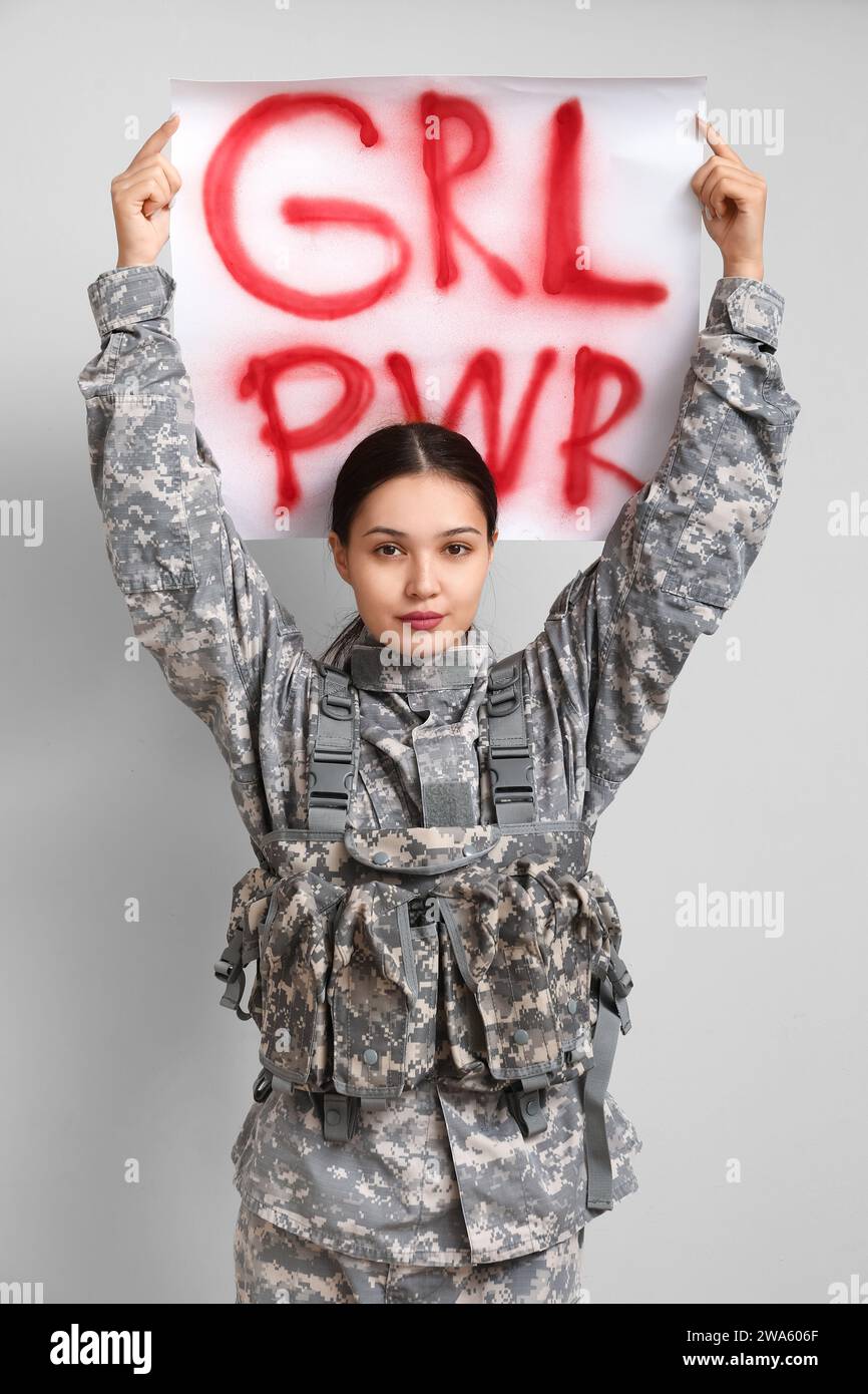 Young female soldier with sign GRL PWR on white background. Feminism ...