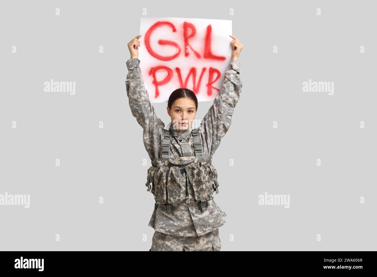 Young female soldier with sign GRL PWR on white background. Feminism ...