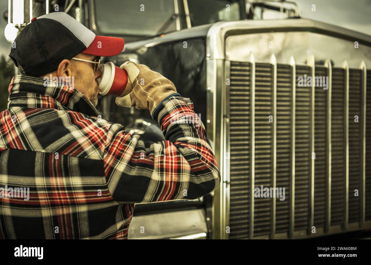 Professional Long Haul Trucker Driver Drinking a Coffee Next to His ...