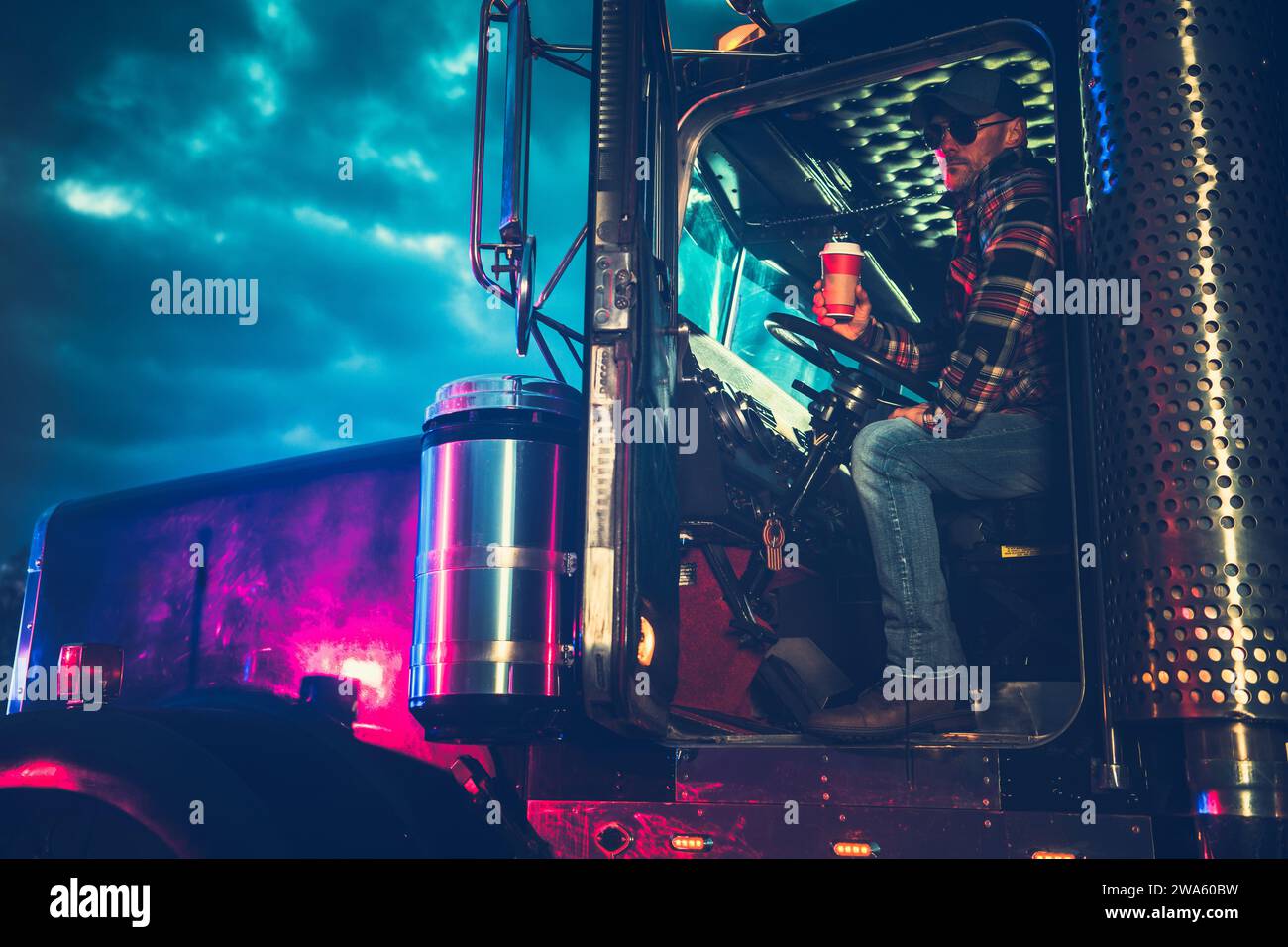 Trucker Driver Drinking a Coffee While on a Truck Stop. Heavy Duty ...