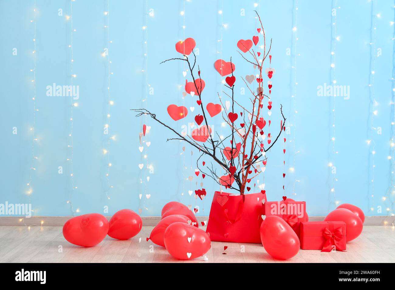 Tree branches with paper heart garland, heart-shaped balloons and ...