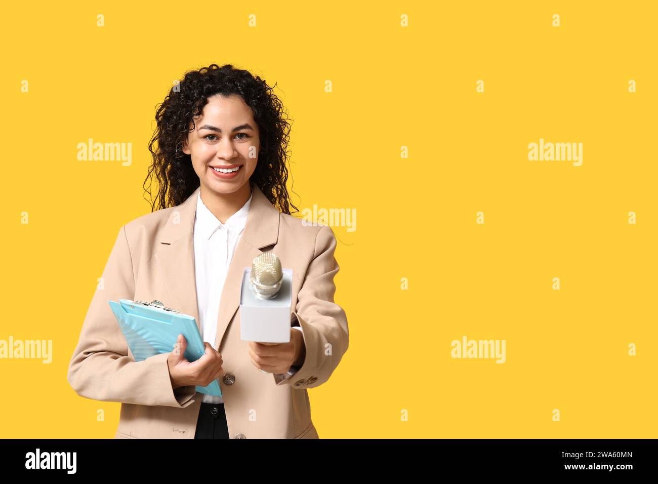 Beautiful young happy African-American female journalist with ...
