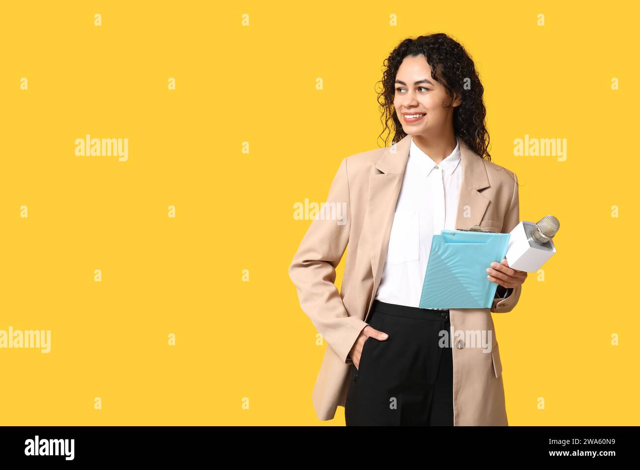 Beautiful young happy African-American female journalist with ...
