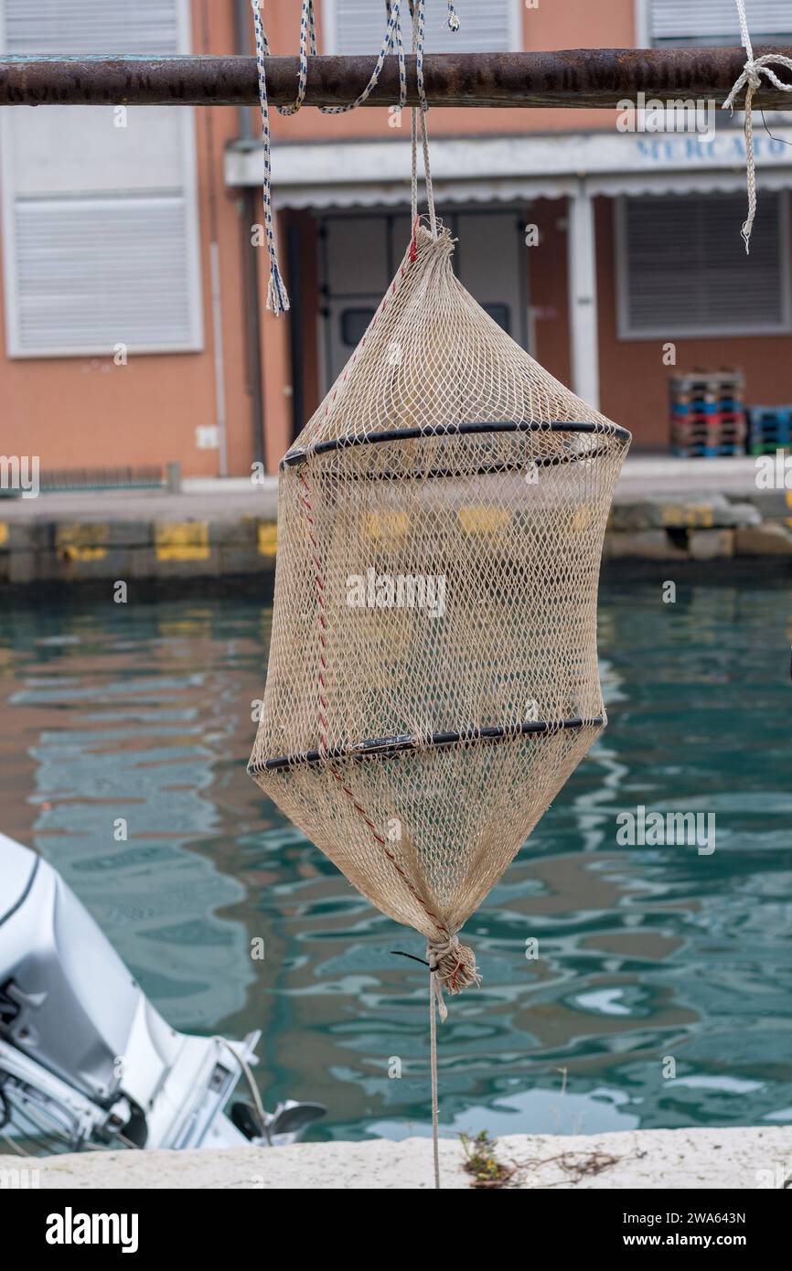 Items for fishing set found on the port of Grado. Typical keepnet that ...