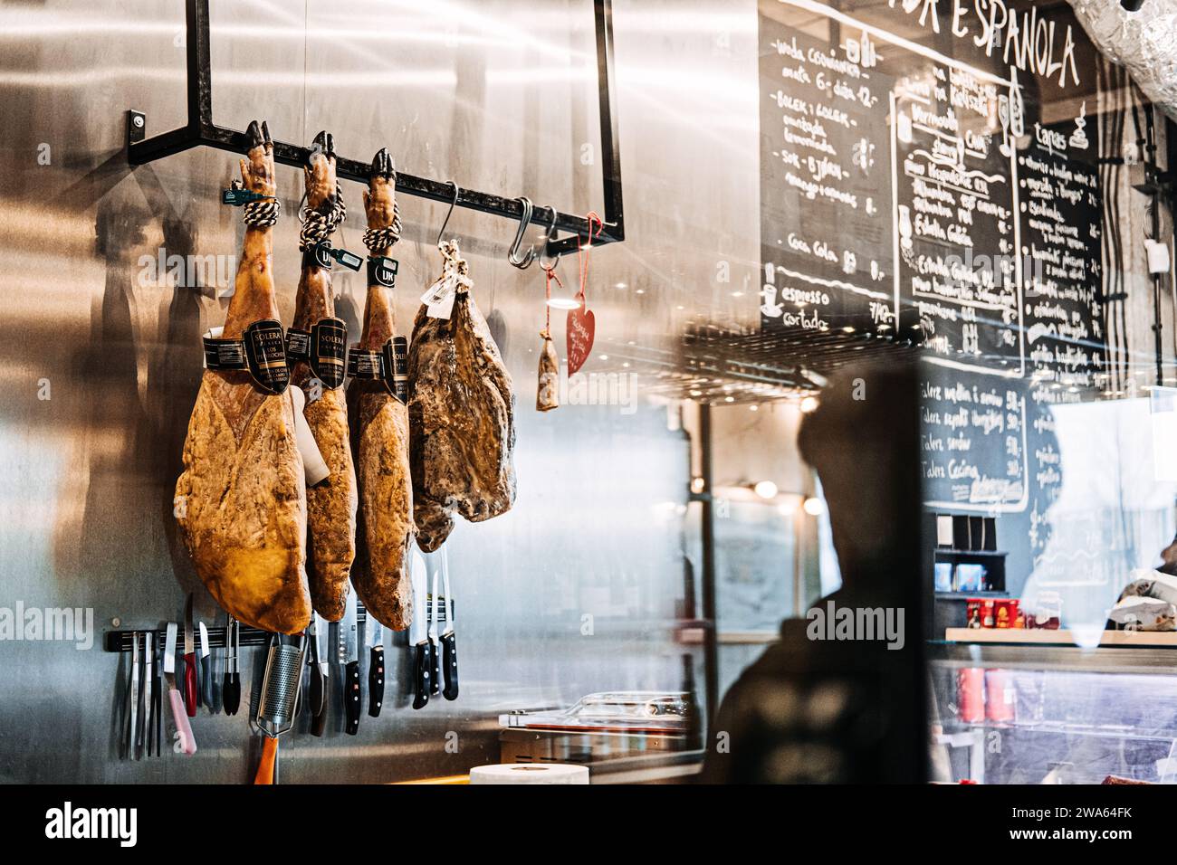 Cured Hams Hanging in a Spanish Delicatessen. Traditional Spanish cured ...