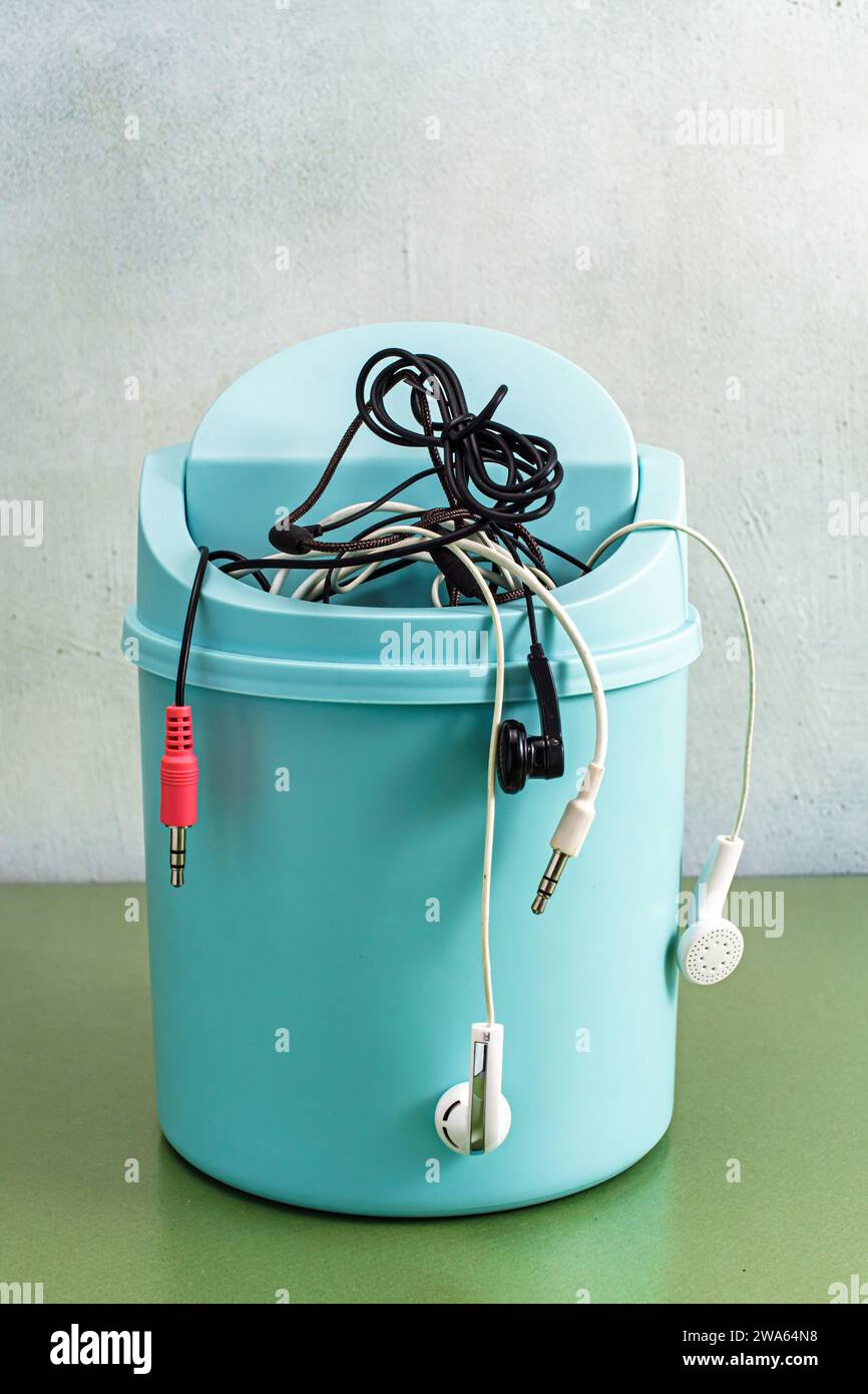 Lots of wired headphones in a plastic office trash can Stock Photo - Alamy