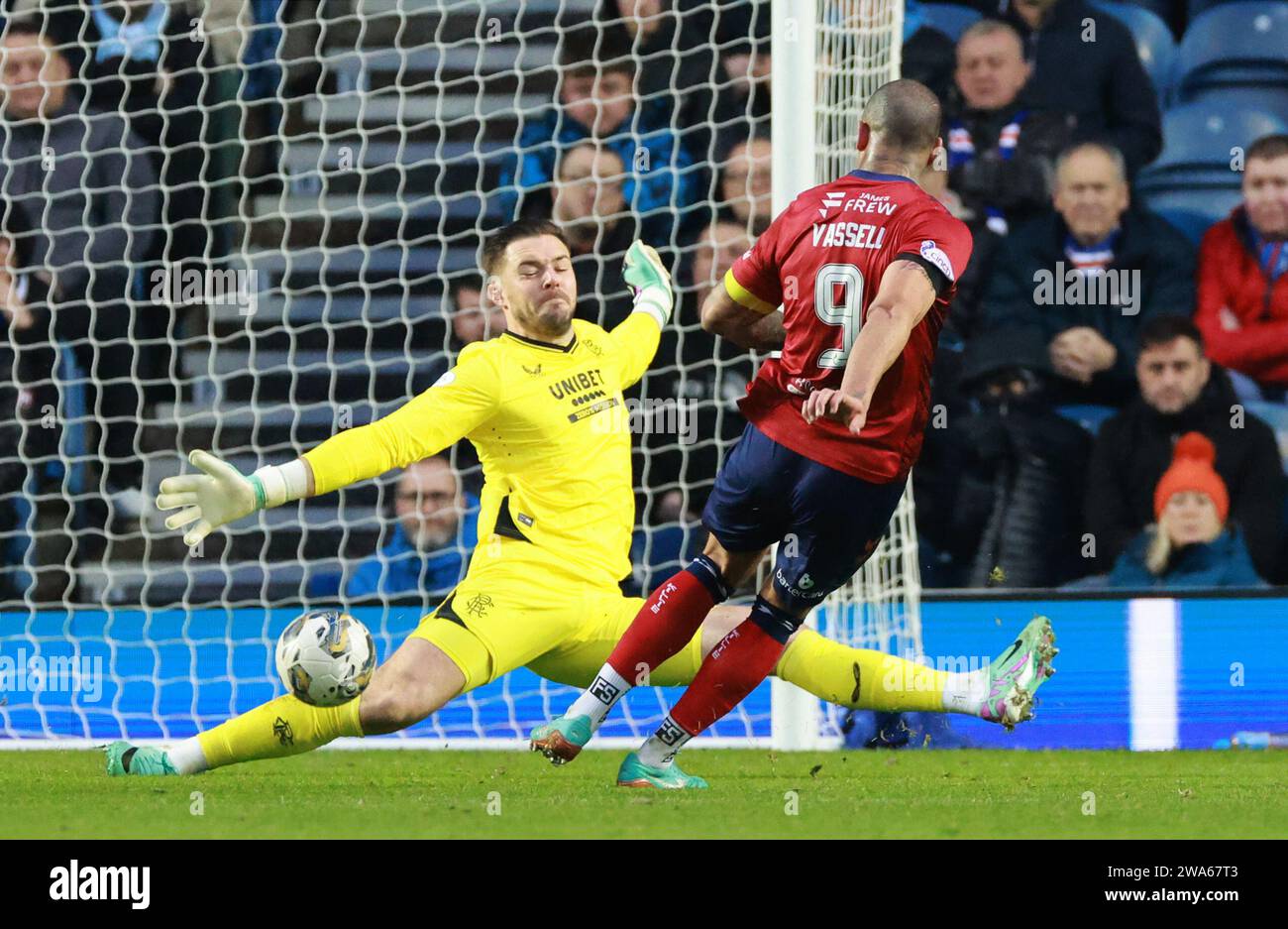 Rangers goalkeeper Jack Butland saves from Kilmarnock's Kyle Vassell ...