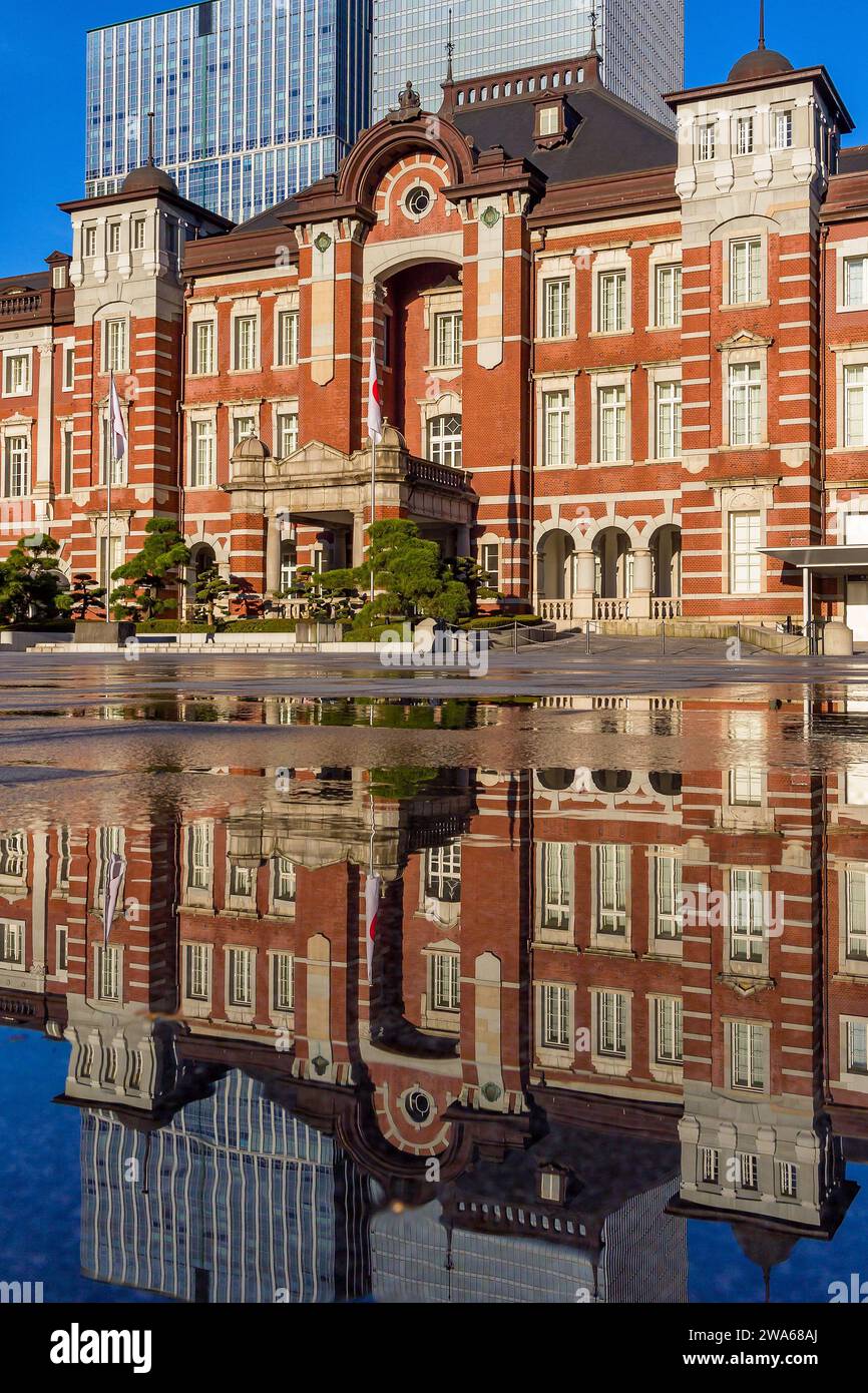 Beautiful reflection of the red brick Tokyo Station in water sprayed to ...