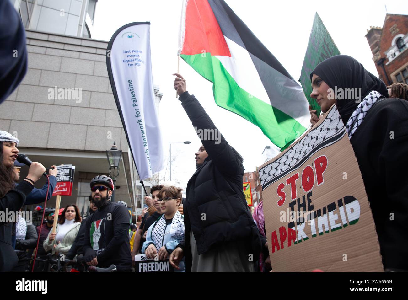 Pro-Palestinian protesters gather with flags and placards during a ...