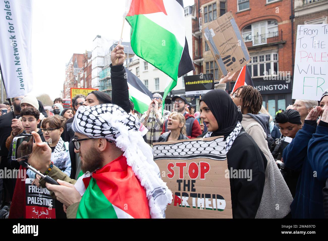 Pro-Palestinian protesters gather with flags and placards during a ...