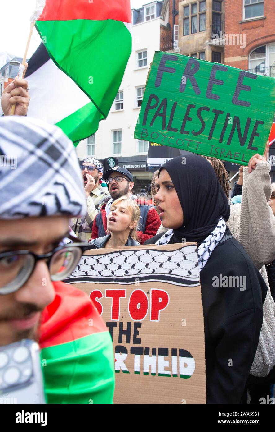Pro-Palestinian protesters gather with flags and placards during a ...