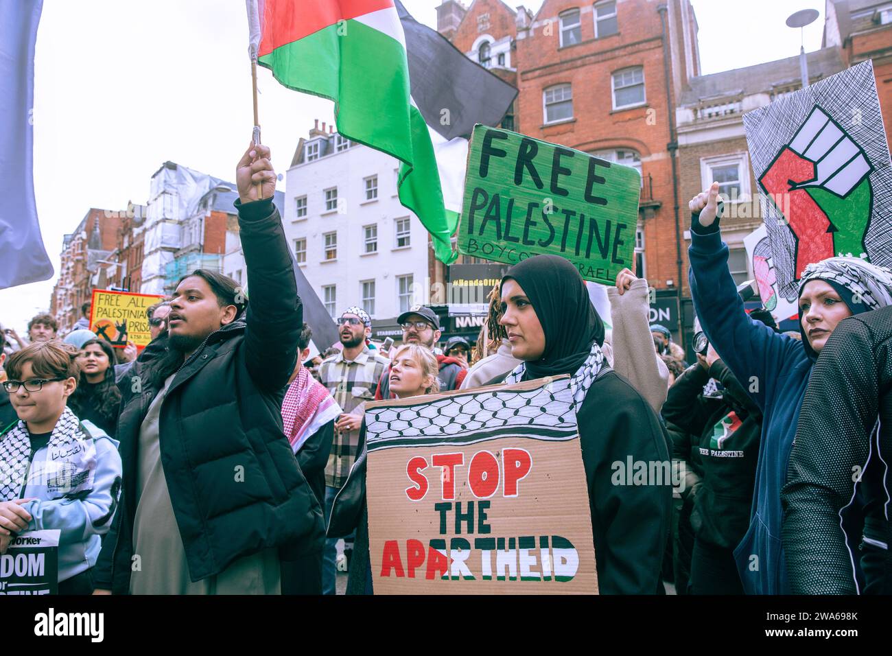 Pro-Palestinian protesters gather with flags and placards during a ...