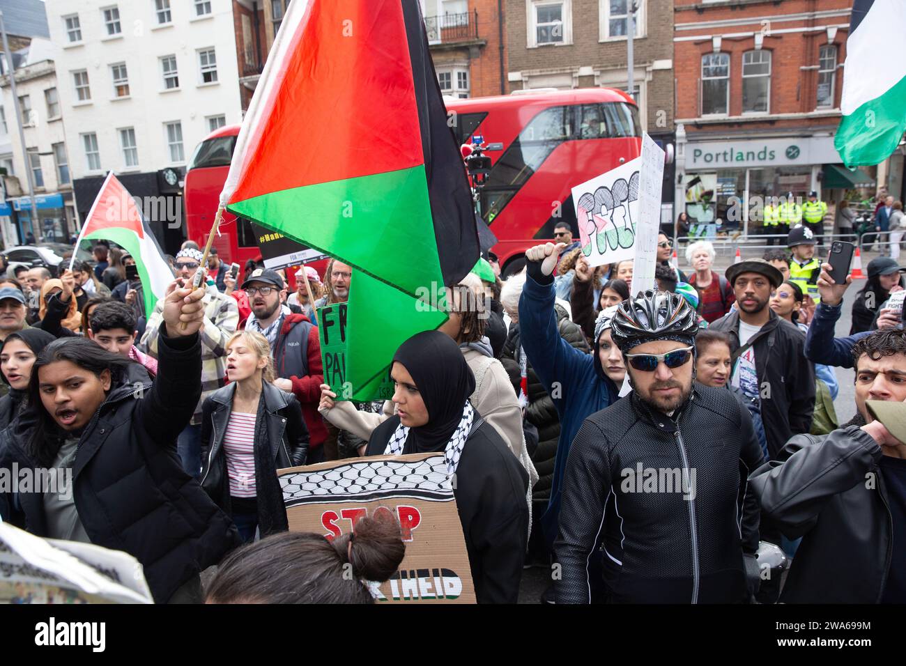 Pro-Palestinian protesters gather with flags and placards during a ...