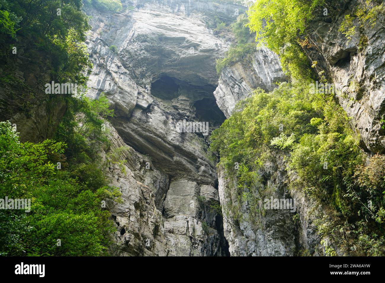 There are two round holes on the karst mountain wall that look like ...