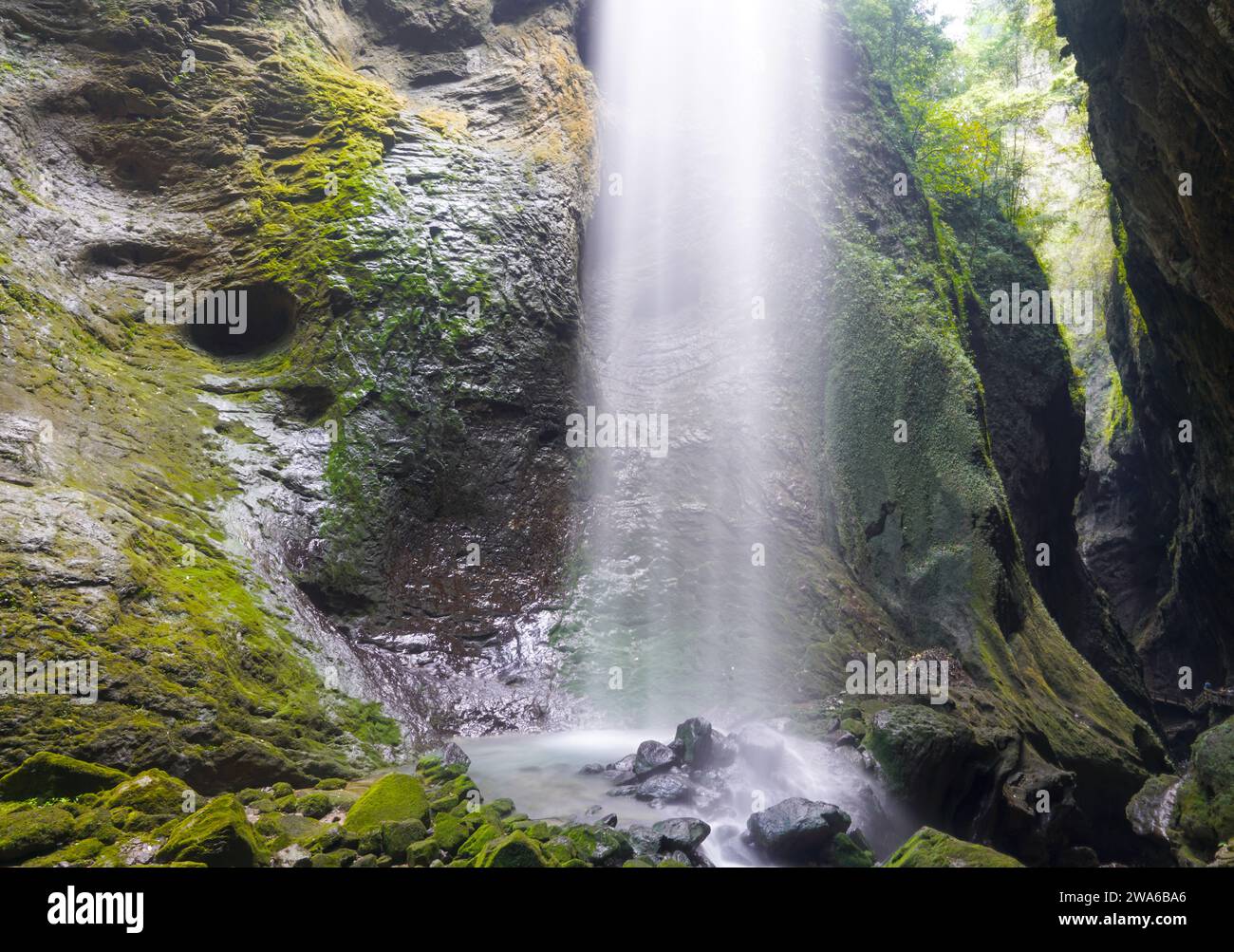 Waterfalls in the canyon fall from the sky. Like a silver-white chain ...