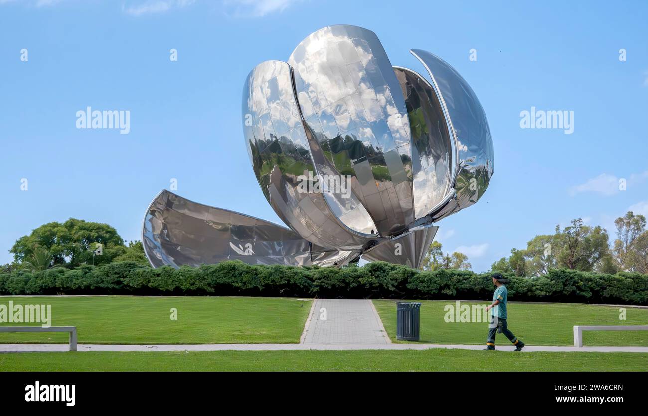 A parks employee walks past the storm damaged Floralis Genérica metal ...