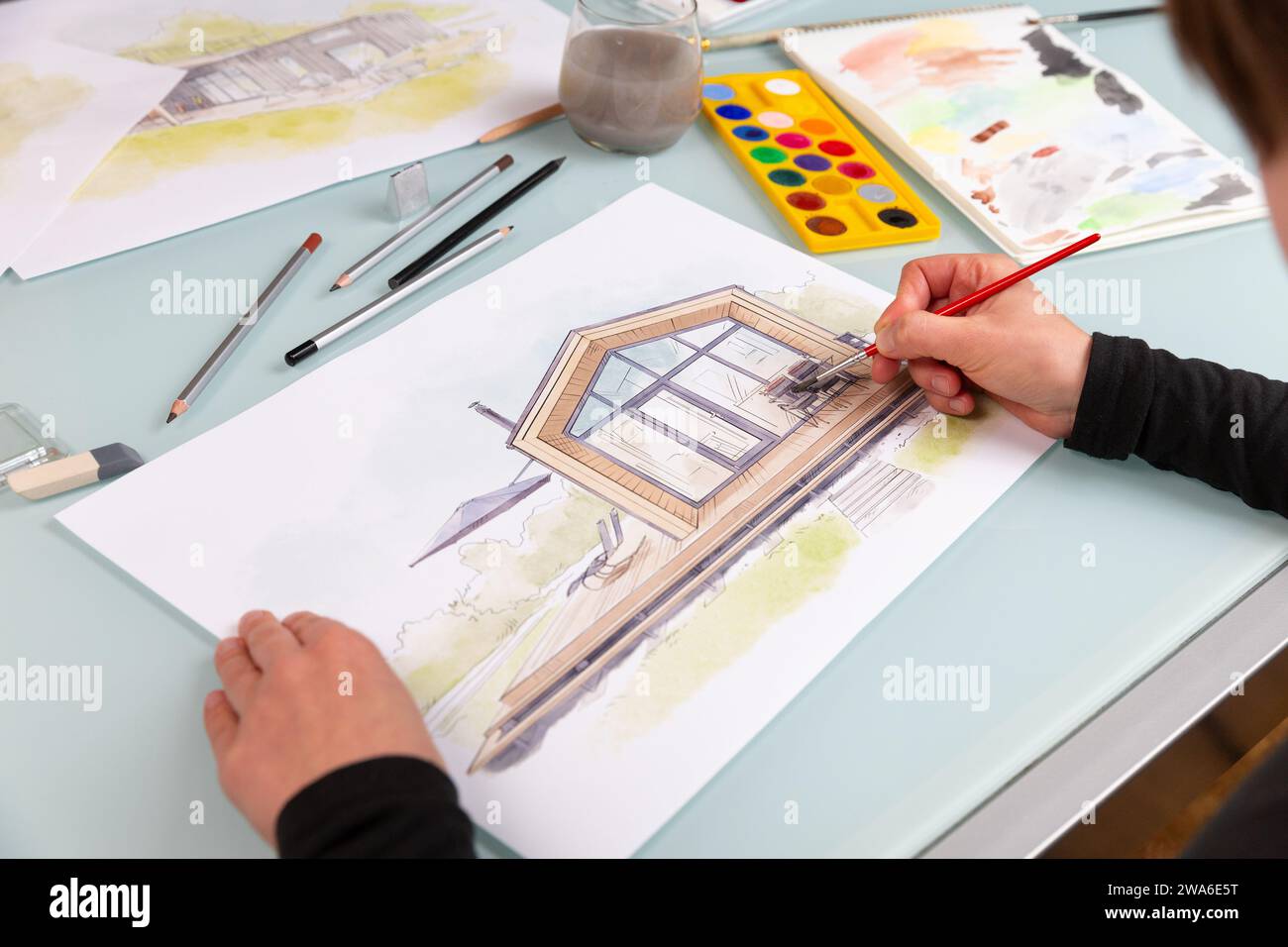 Architect illustrator working on hand drawn illustration of a modular ...
