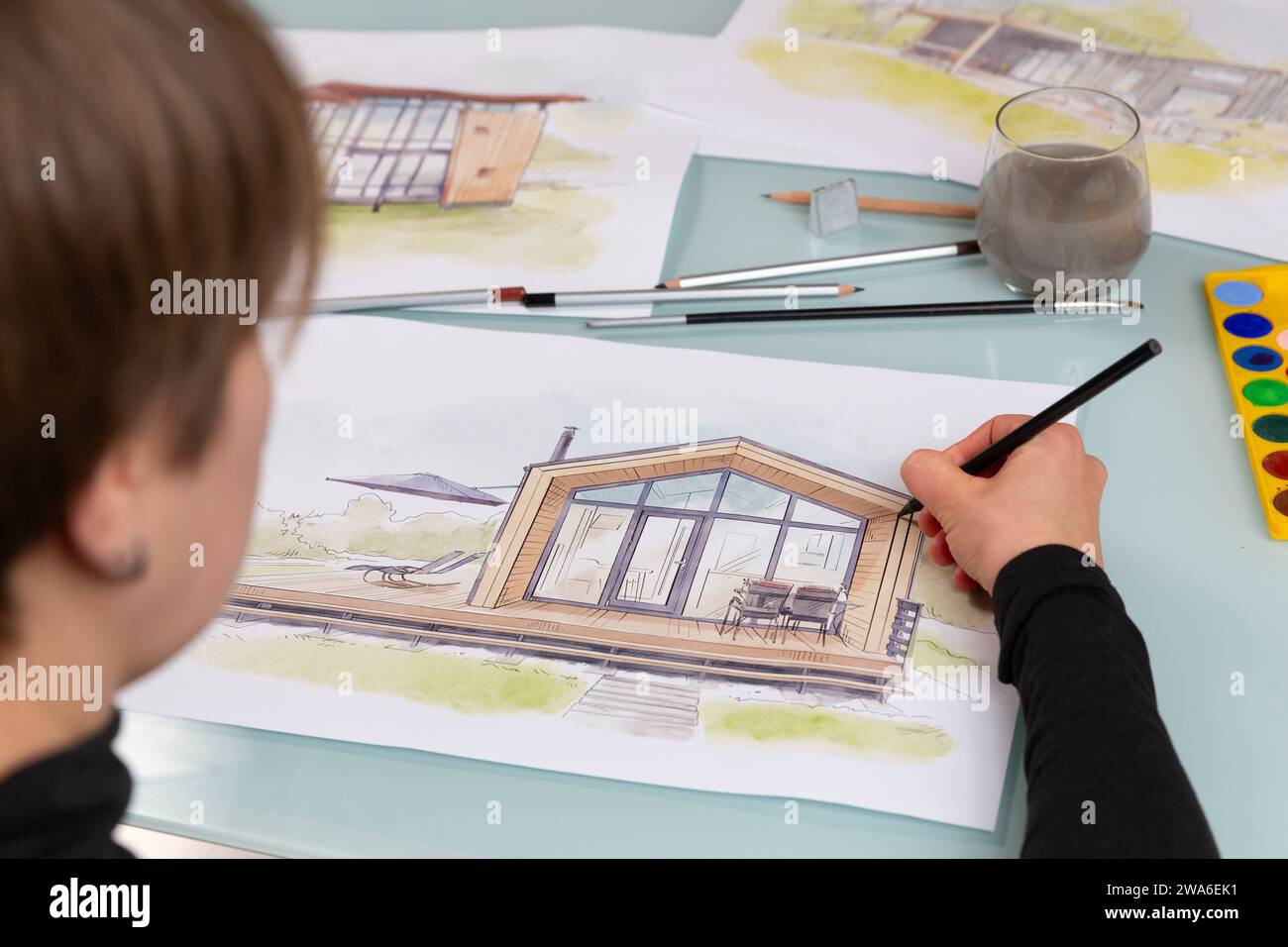 Architect illustrator working on hand drawn illustration of a modular ...