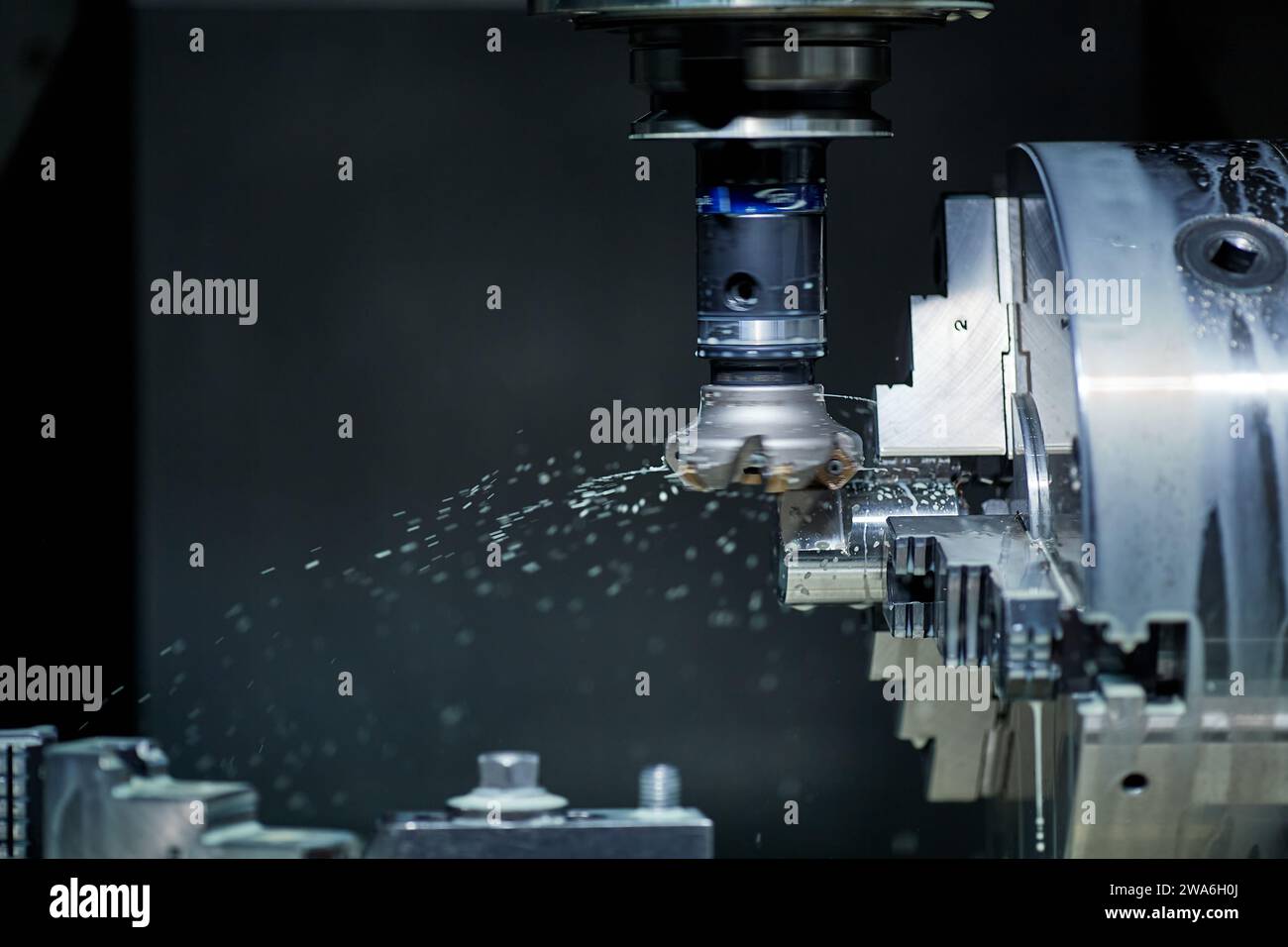 vertical milling machine close-up processes a part in production ...