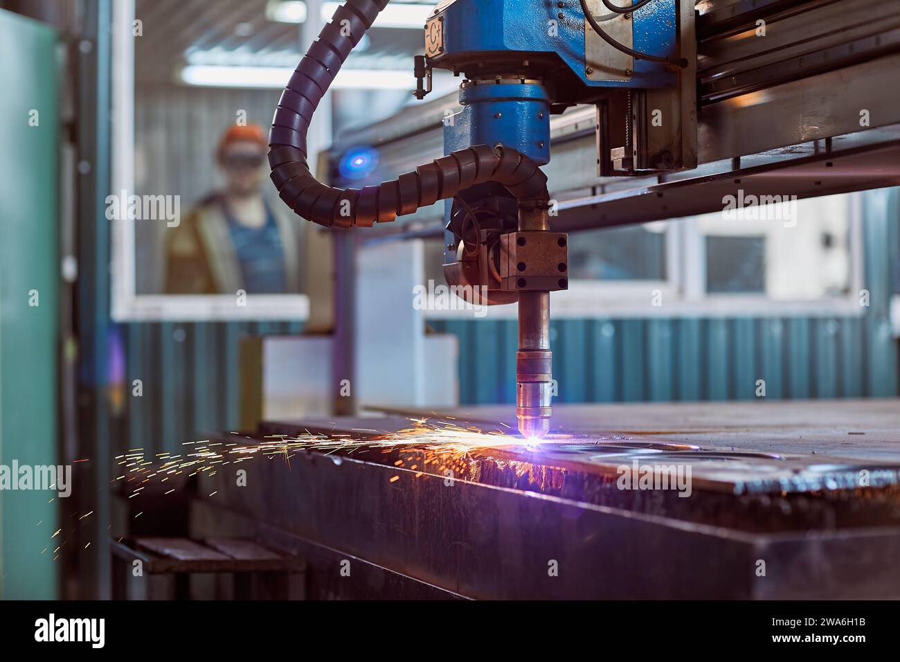 CNC laser plasma. Selective focus on modern technology laser plasma cutting of metal in process ...