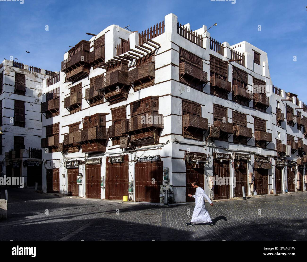 Man Walking Past Tall Building in Al Balad, Historical district of ...