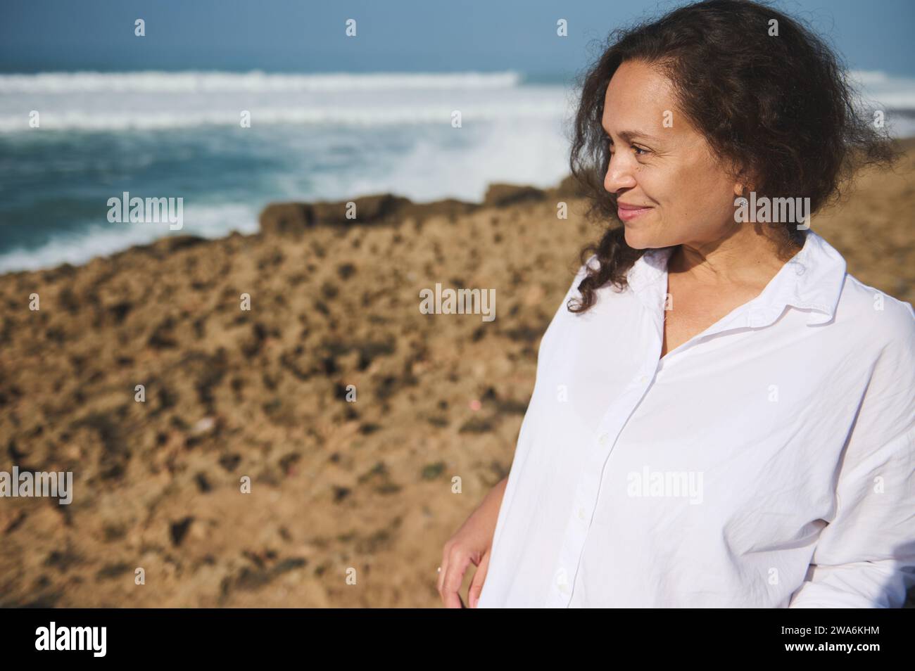 Authentic portrait of charming African American woman in white casual ...
