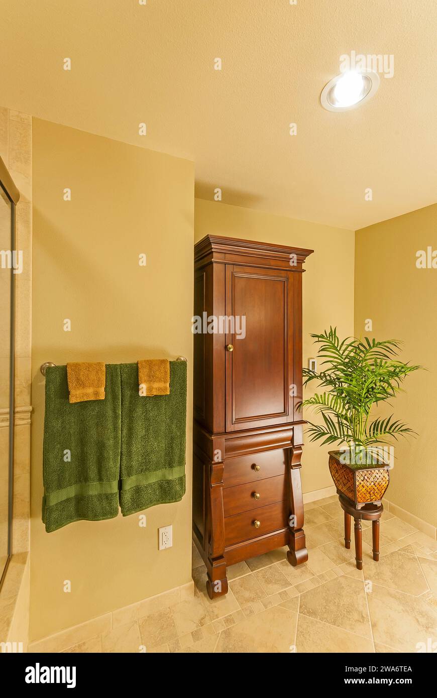 Remodeled bathroom in a middle-class home. A piece of wooden furniture ...