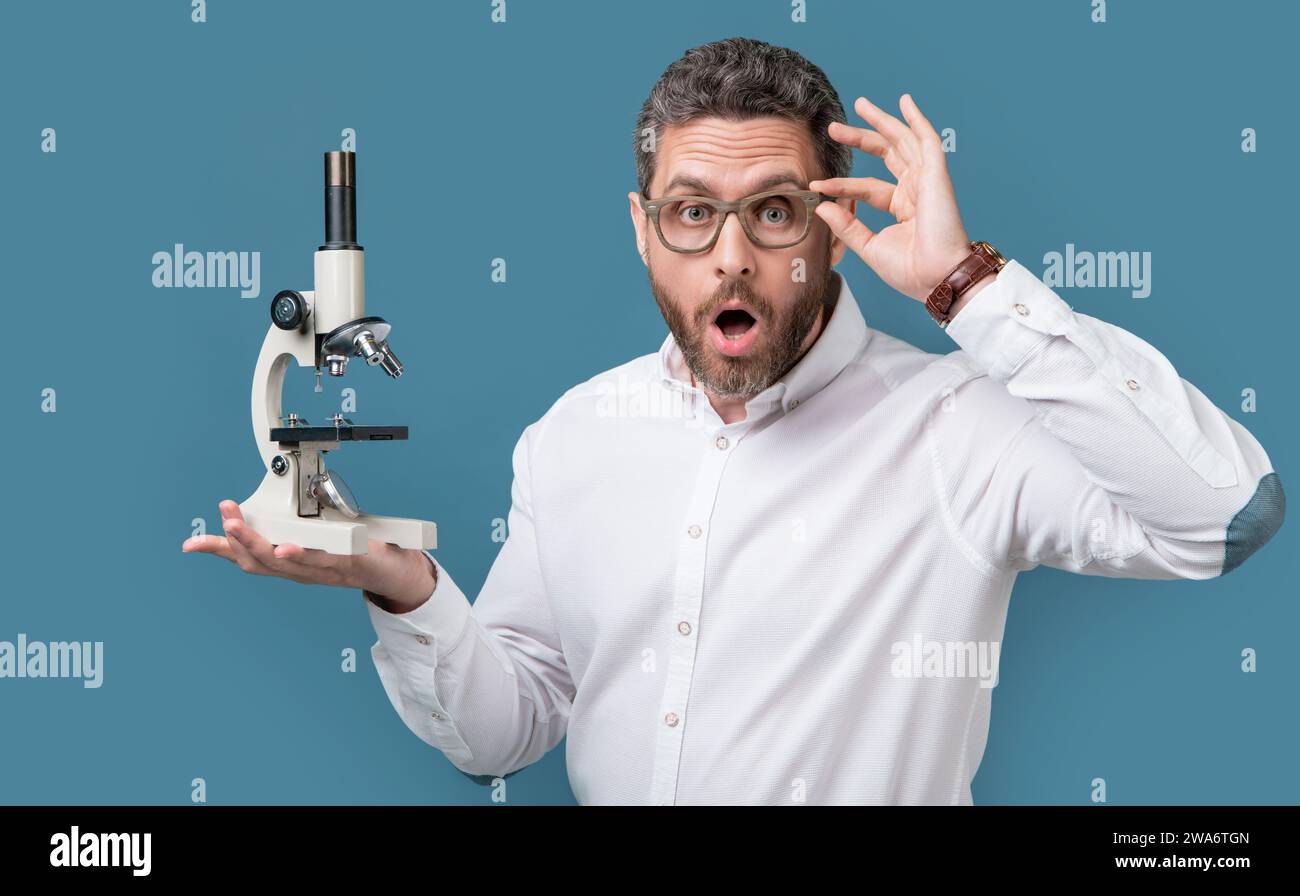 surprised man with invention microscope isolated on blue background ...