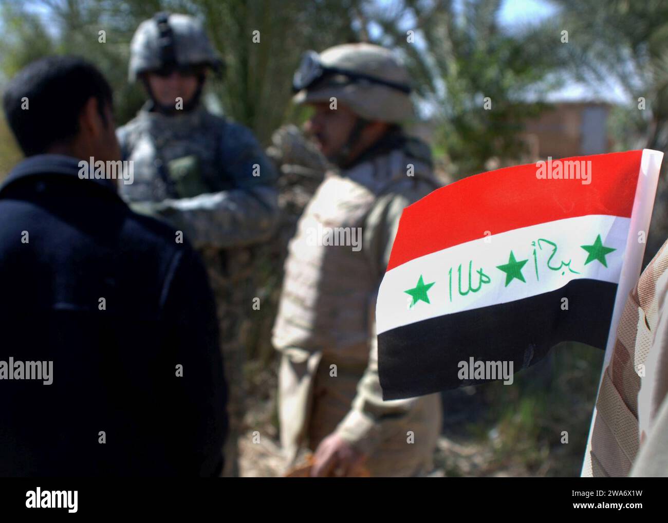 US military forces. Iraqi flag adorns Iraqi soldier's uniform as U.S ...