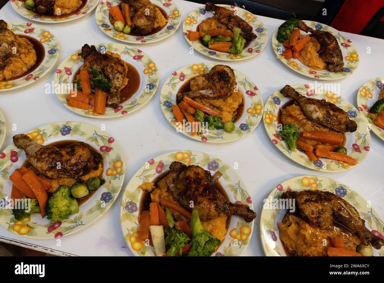 Plates of Christmas dinner lined up and ready to be served at a ...